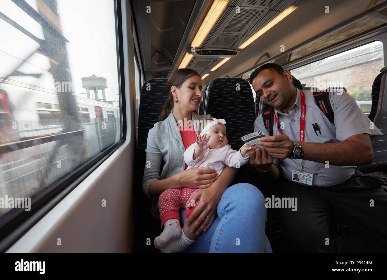 Young mother travelling with baby girl on the train Stock Photo - Alamy