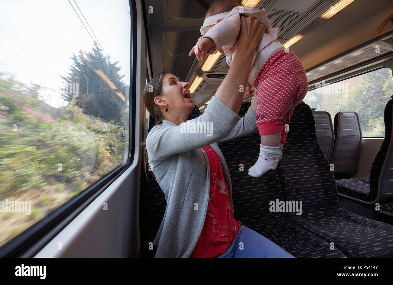 Young mother travelling with baby girl on the train Stock Photo - Alamy