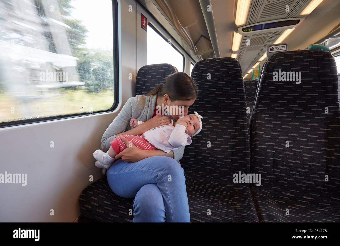 Young mother travelling with baby girl on the train Stock Photo - Alamy