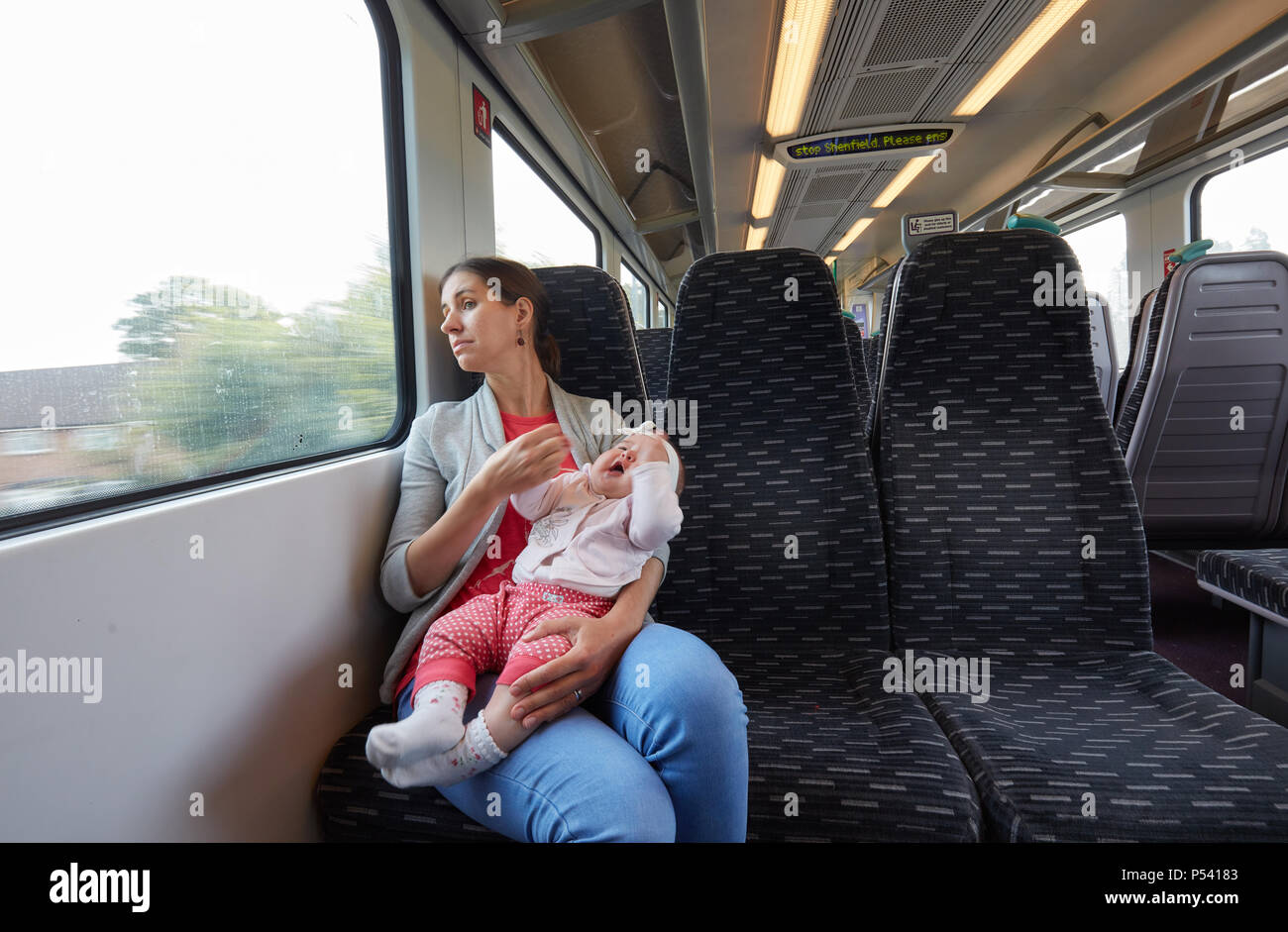 Young mother travelling with baby girl on the train Stock Photo - Alamy