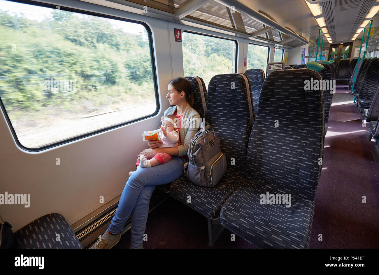 Young mother travelling with baby girl on the train Stock Photo - Alamy
