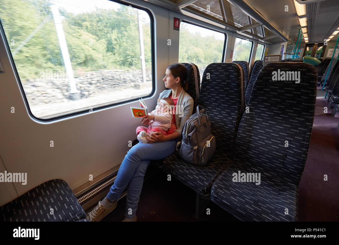 Young mother travelling with baby girl on the train Stock Photo - Alamy