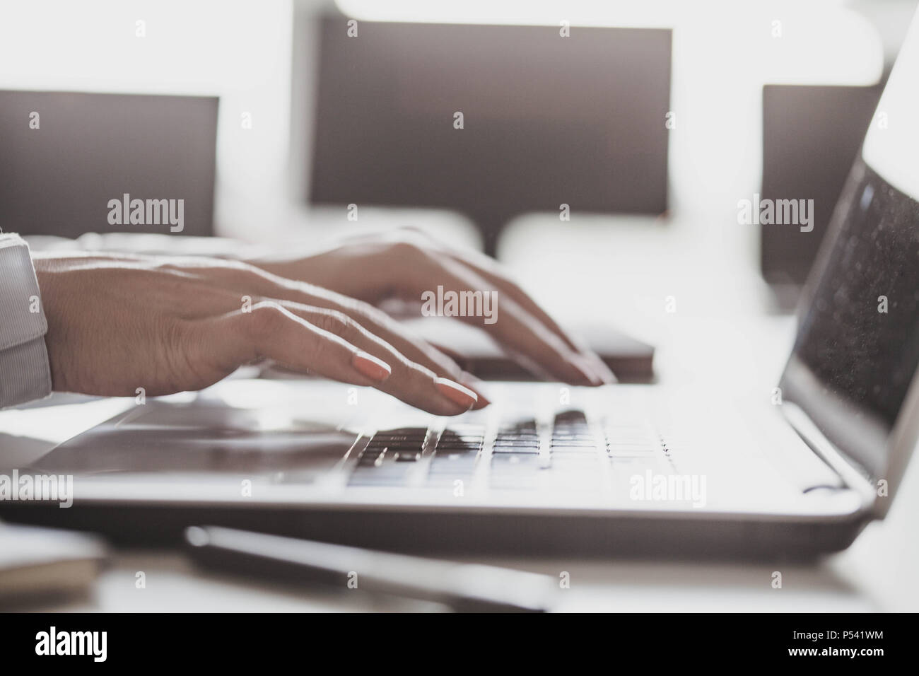 Closeup of a female hands busy typing on a laptop Stock Photo - Alamy
