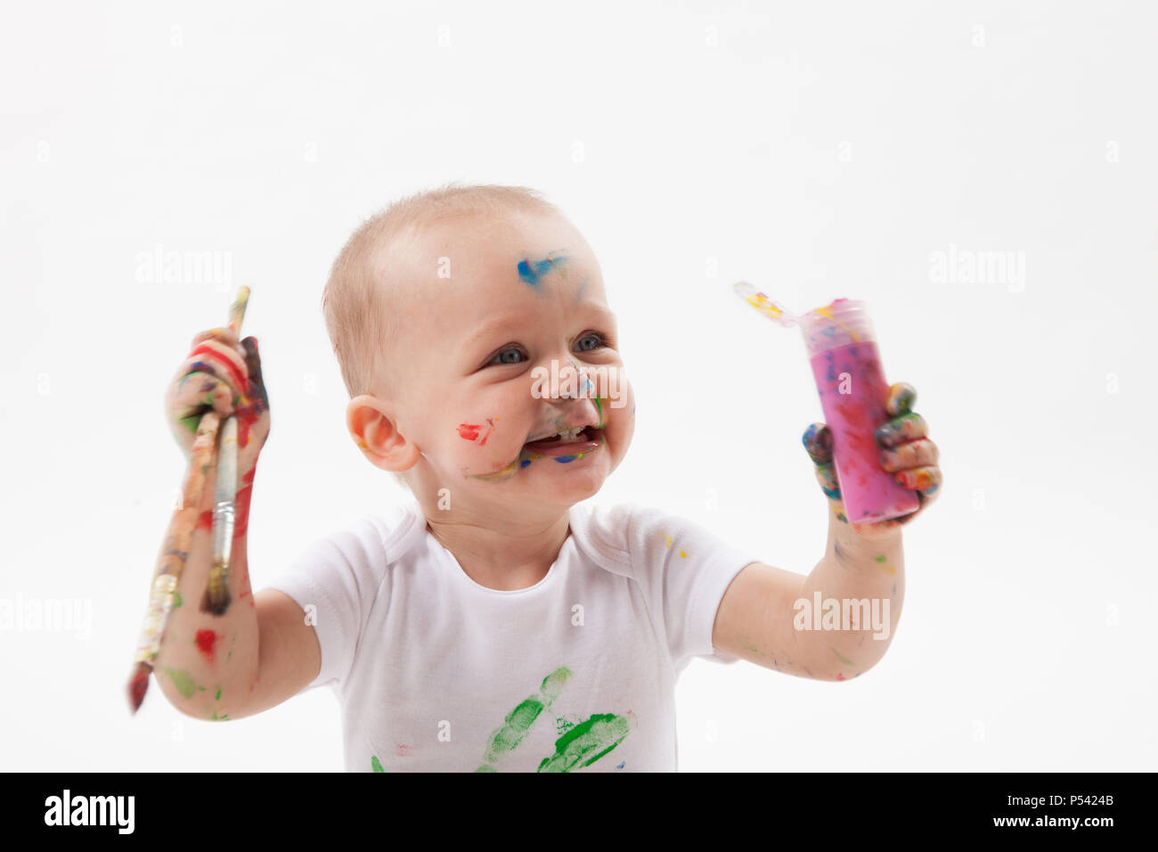 Cute little baby painting with paintbrush and colorful paints on white ...