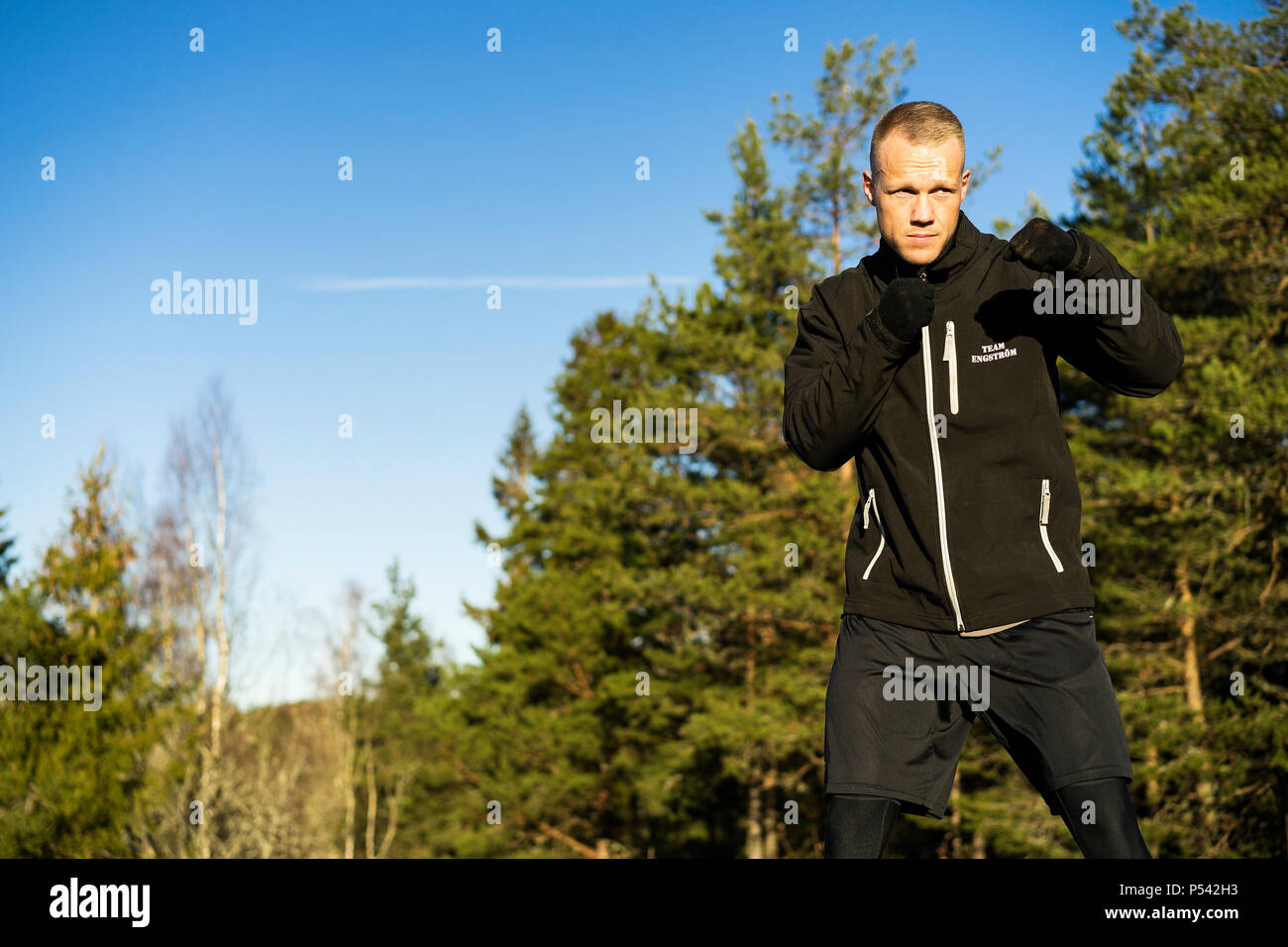 Male caucasian middle age boxer training outside in nature. Nice sunny ...