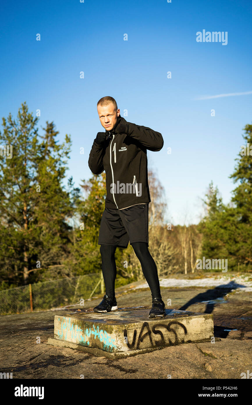 Male caucasian middle age boxer training outside in nature. Nice sunny ...