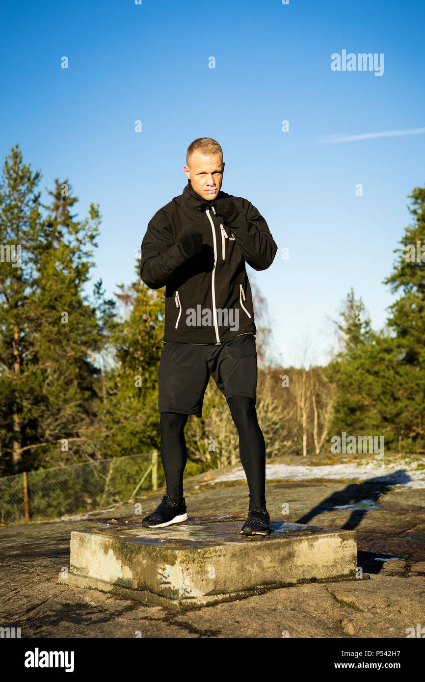 Male caucasian middle age boxer training outside in nature. Nice sunny ...