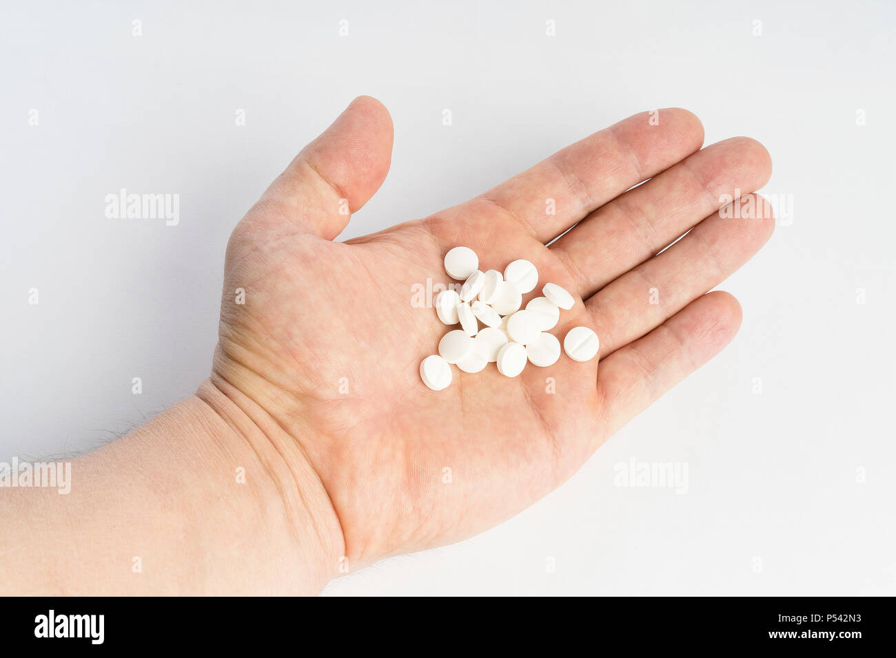 Open hand with medicine tablets isolated on white background ...