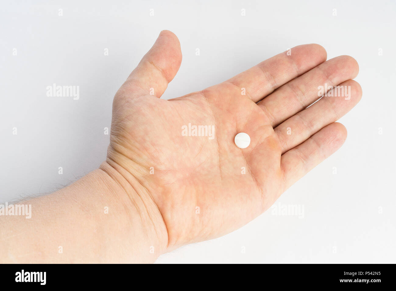 Open hand with medicine tablets isolated on white background ...