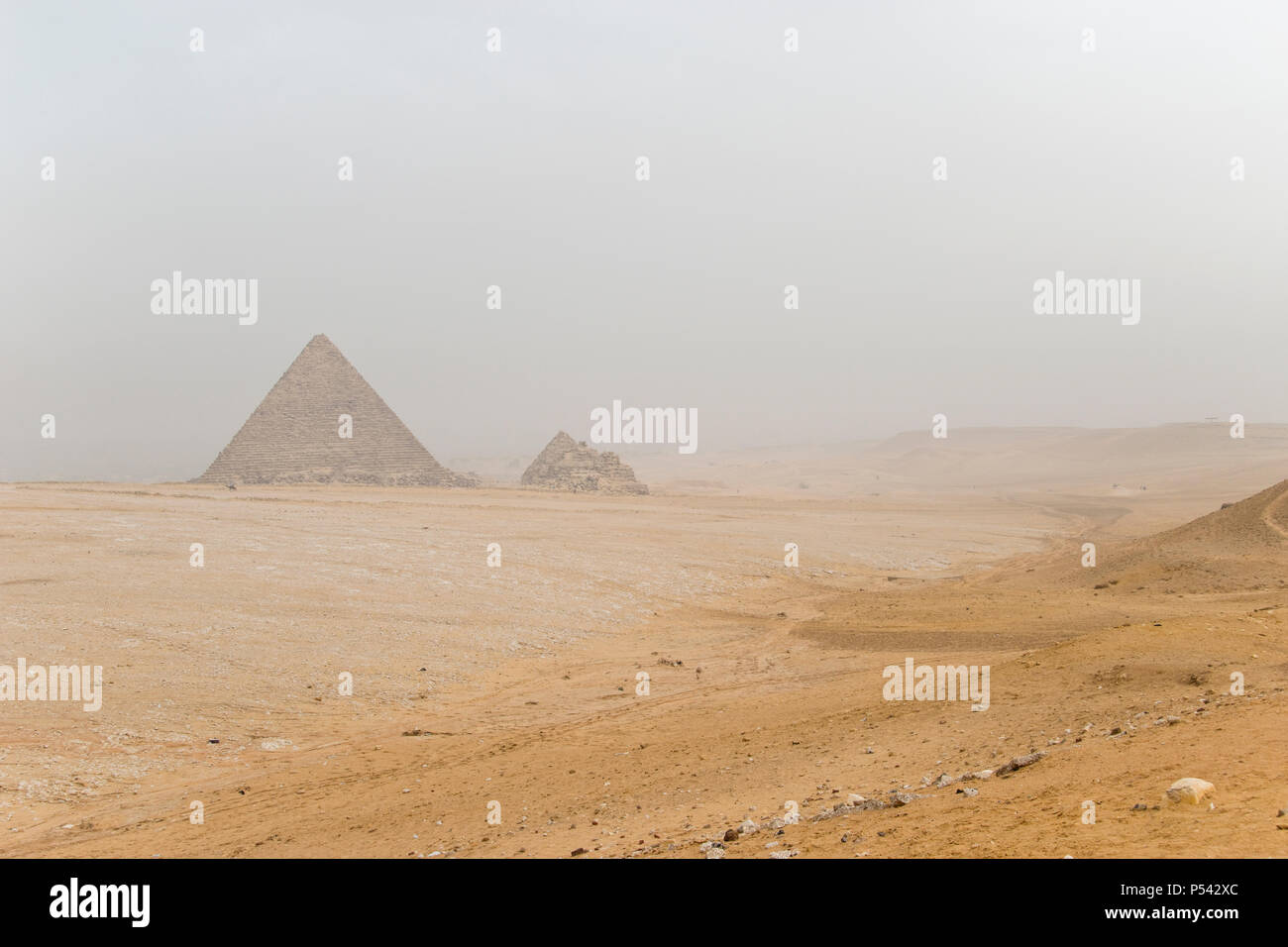 The desert landscape at Menkaure Pyramid (left), and three small “queen ...