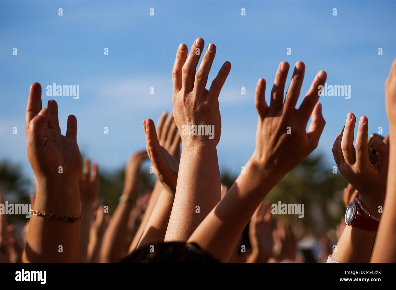 Crowded people hands up at a day time concert Stock Photo - Alamy
