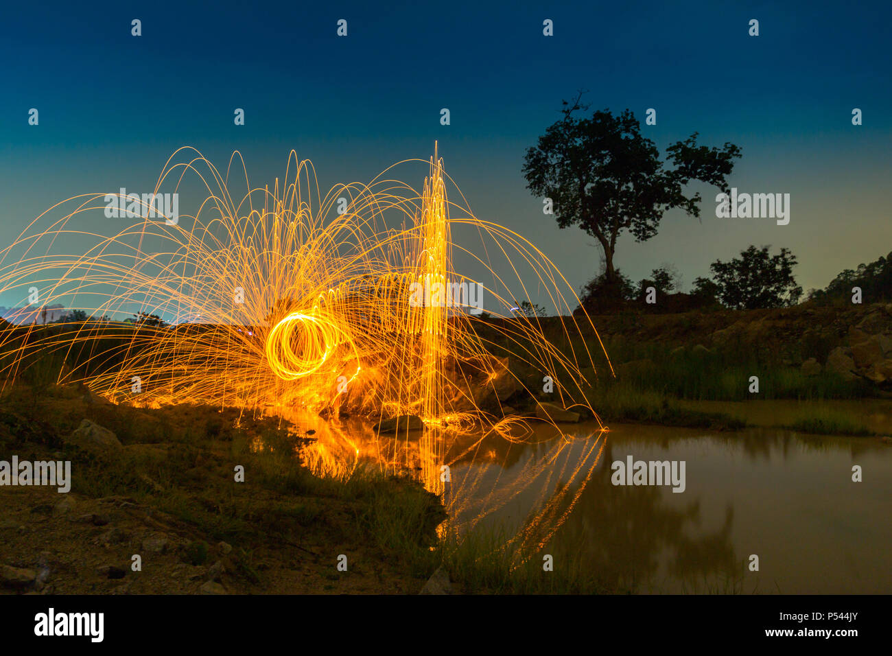 burning steel wool on the mountain rock above lagoon Stock Photo - Alamy