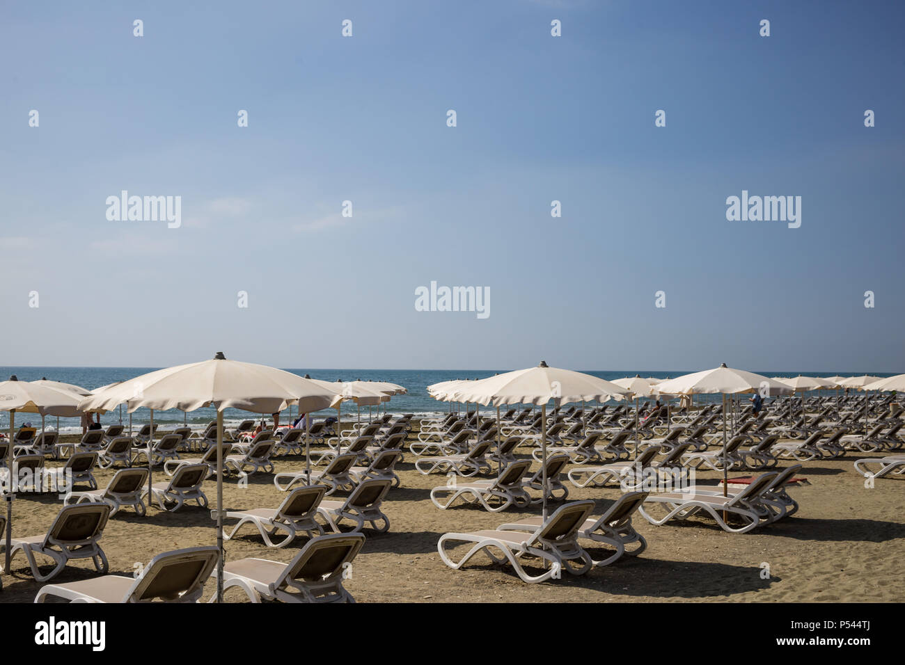 Mackenzie sandy beach at Larnaca, Cyprus. Sun loungers and umbrellas ...