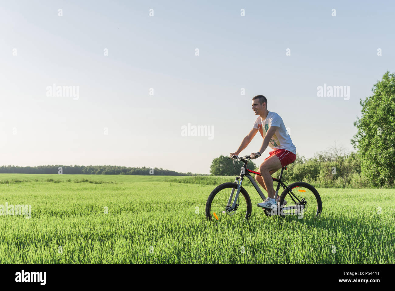 The man is riding a bicycle Stock Photo - Alamy