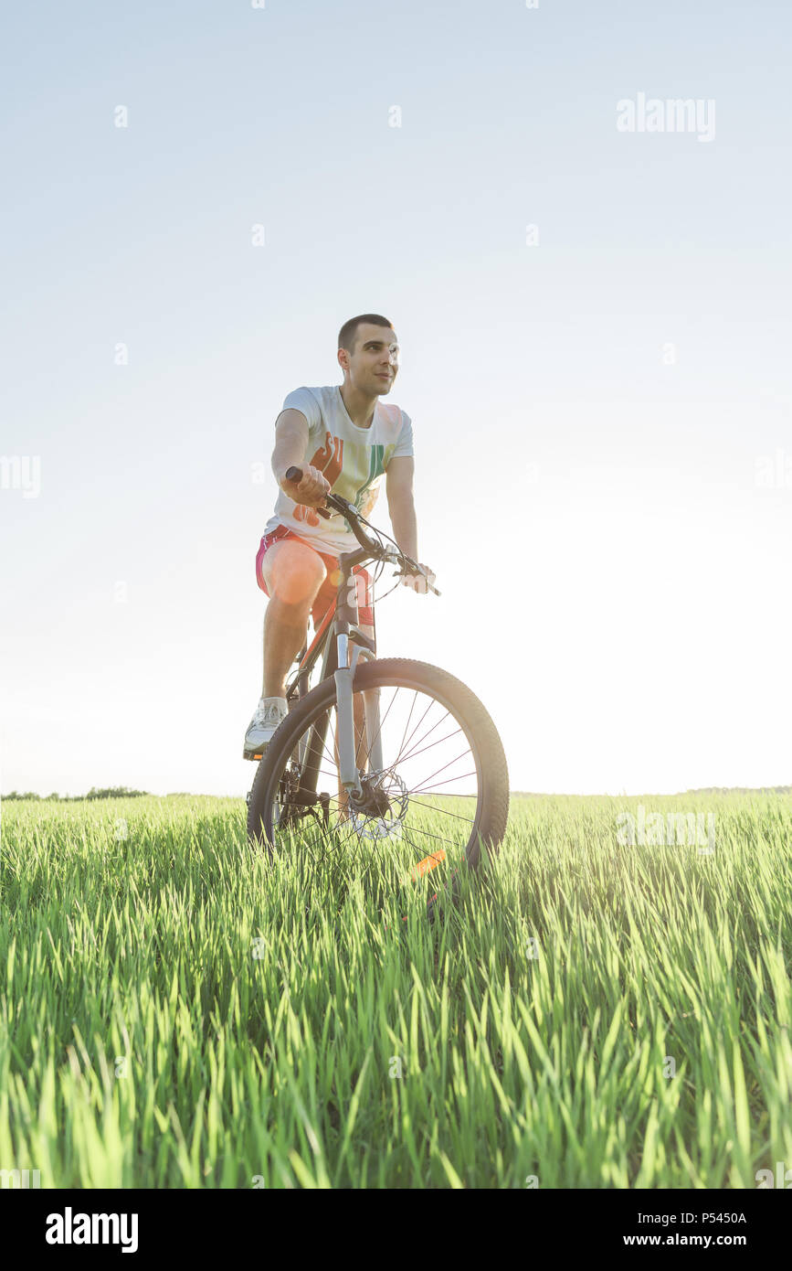The man is riding a bicycle Stock Photo - Alamy