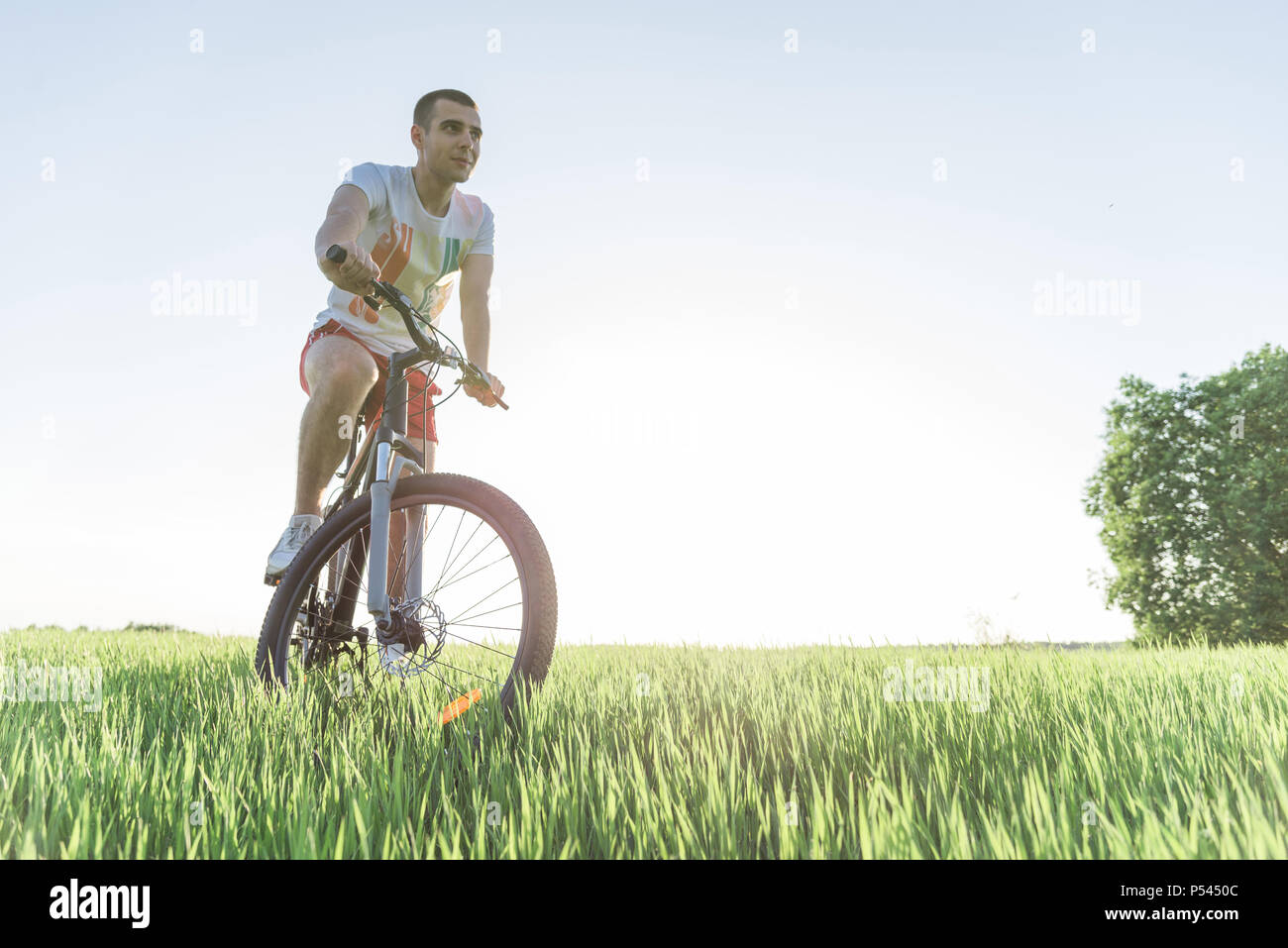 The man is riding a bicycle Stock Photo - Alamy