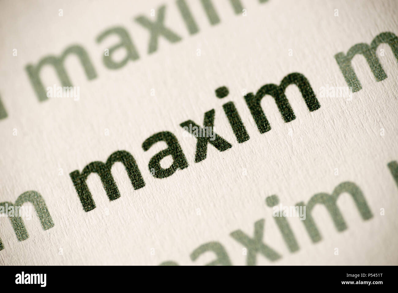 word maxim printed on white paper macro Stock Photo - Alamy