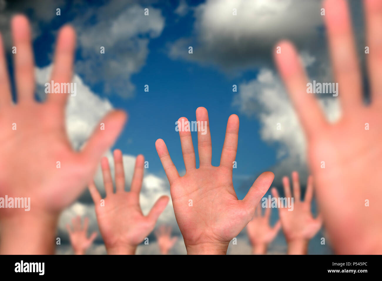 close up shot of several hands up Stock Photo - Alamy