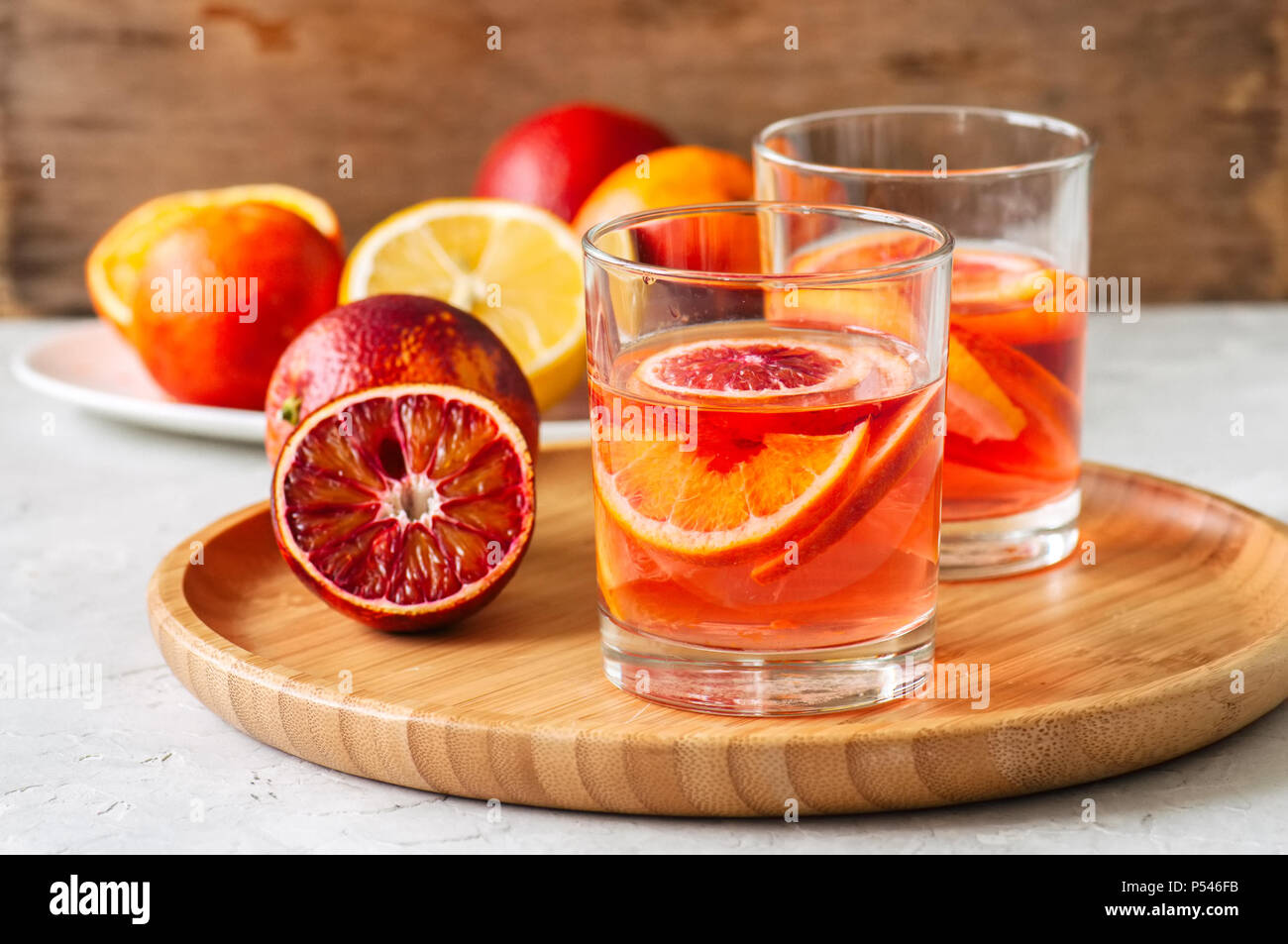 Citrus infused water with slices of fruits. Seasonal beverages concept ...