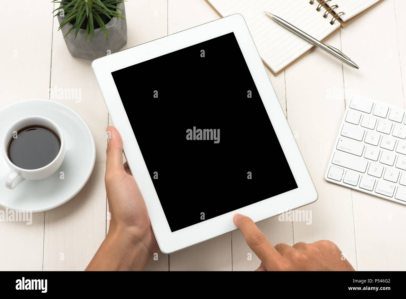 hand using digital tablet finger touch blank screen on desk work table ...