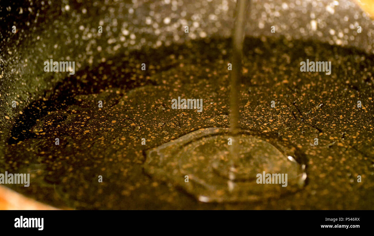 Closeup view pouring vegetable oil into pre heat frying pan Stock Photo ...