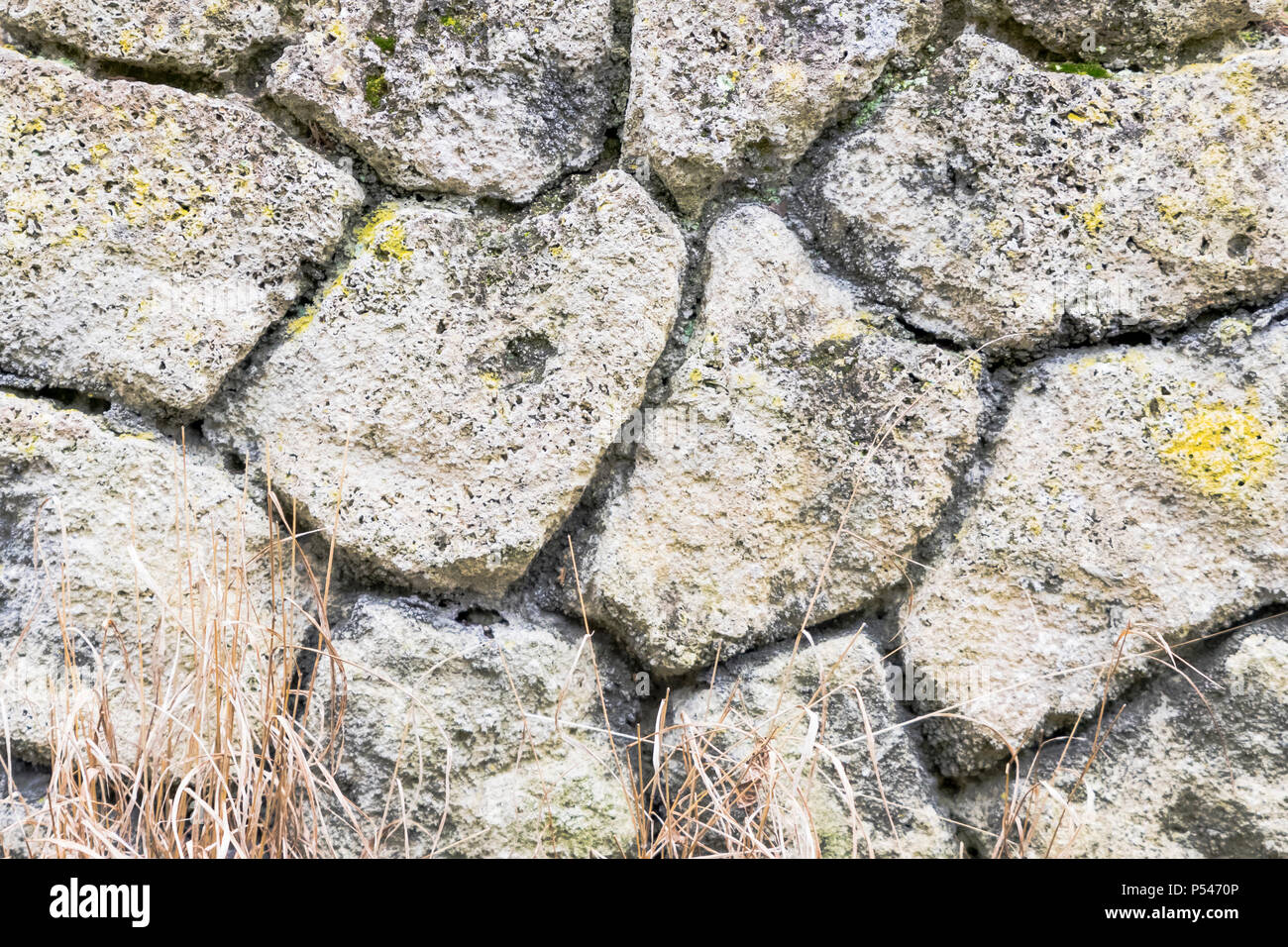 Natural Stone wall made of random stone Stock Photo - Alamy