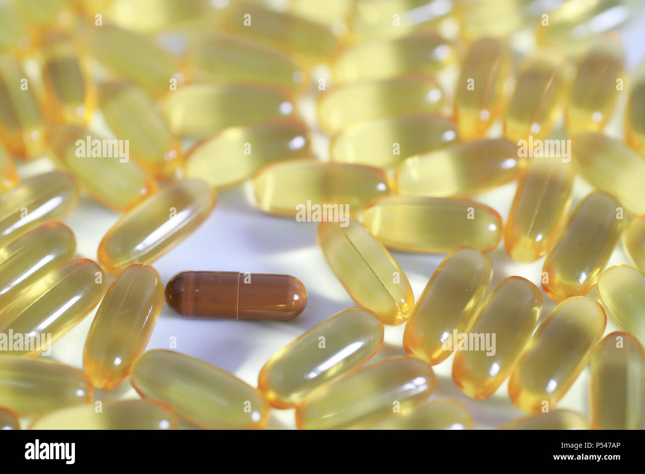 Medical medicines and supplements transparent capsules of yellow color ...
