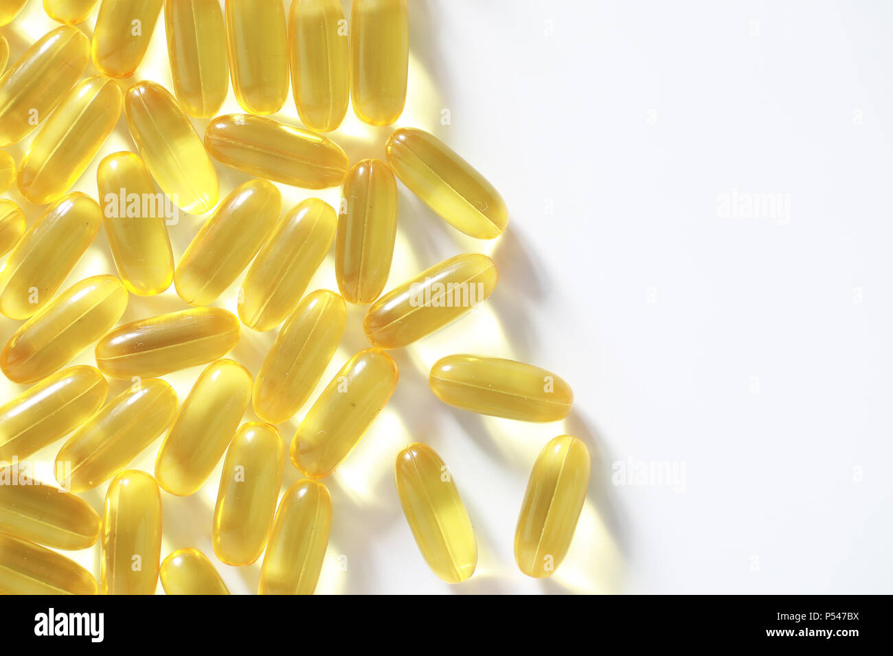 Medical medicines and supplements transparent capsules of yellow color ...