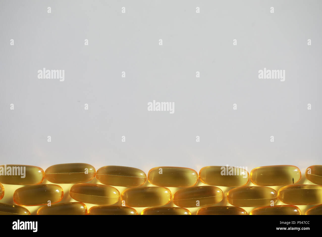 Medical medicines and supplements transparent capsules of yellow color ...