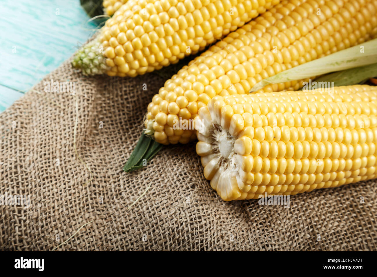 raw heads of corn, on a wooden background top view Stock Photo - Alamy