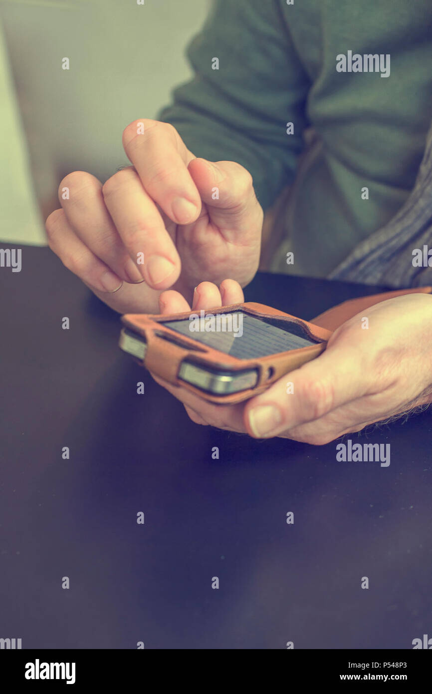Man's hand on smartphone sending a message Stock Photo - Alamy