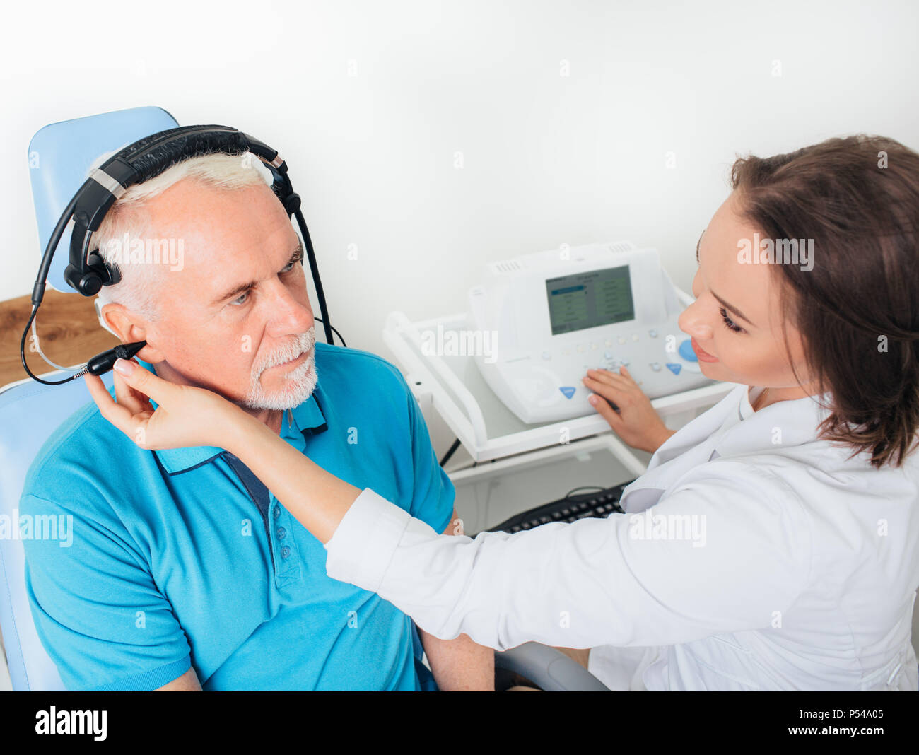 Senior man in hospital having ear test Stock Photo - Alamy