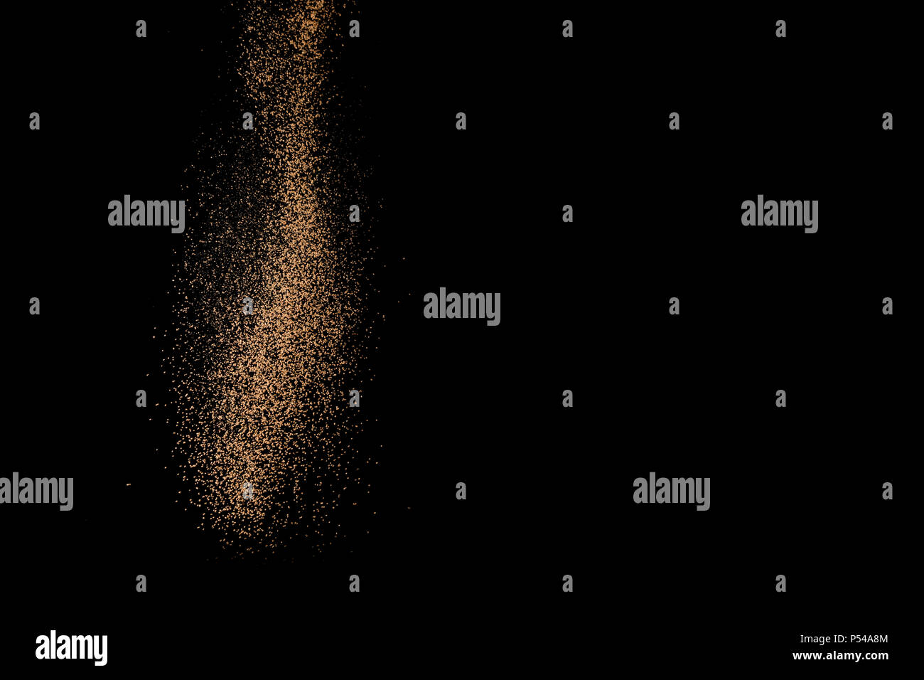 Cocoa powder sifting isolated on black background. Chocolate dust on ...