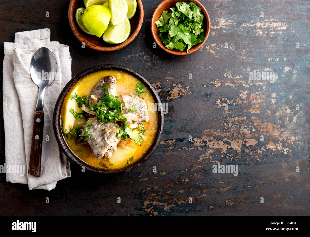CHILEAN FOOD. Fish soup CALDILLO DE CONGRIO served in clay bowl, top ...