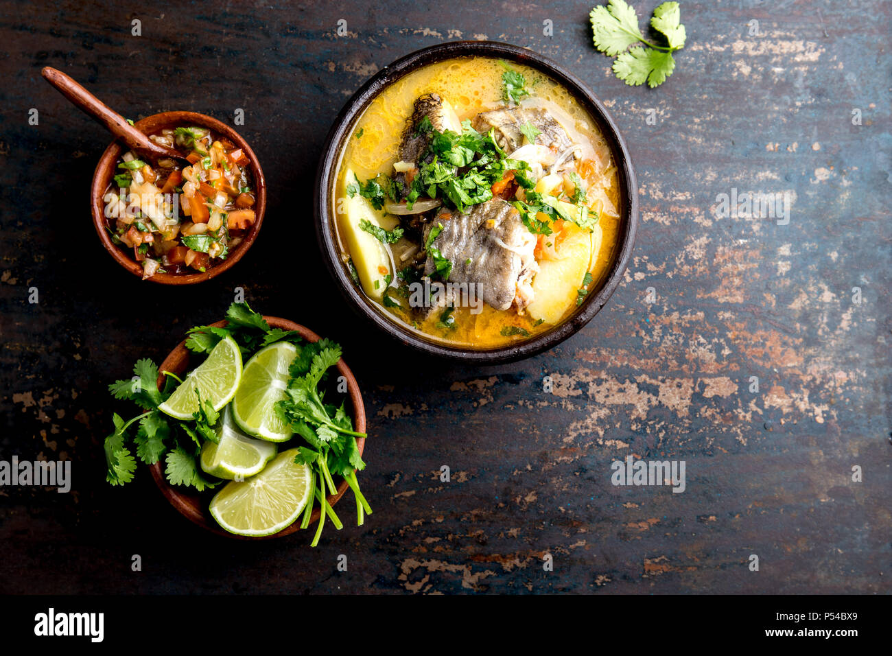 CHILEAN FOOD. Fish soup CALDILLO DE CONGRIO served in clay bowl, top ...