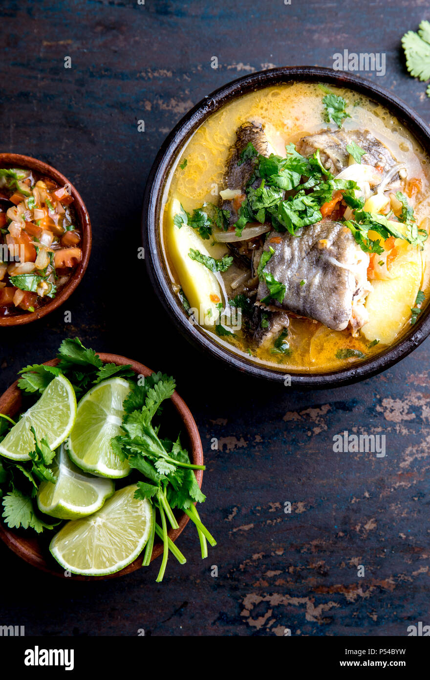 CHILEAN FOOD. Fish soup CALDILLO DE CONGRIO served in clay bowl, top ...