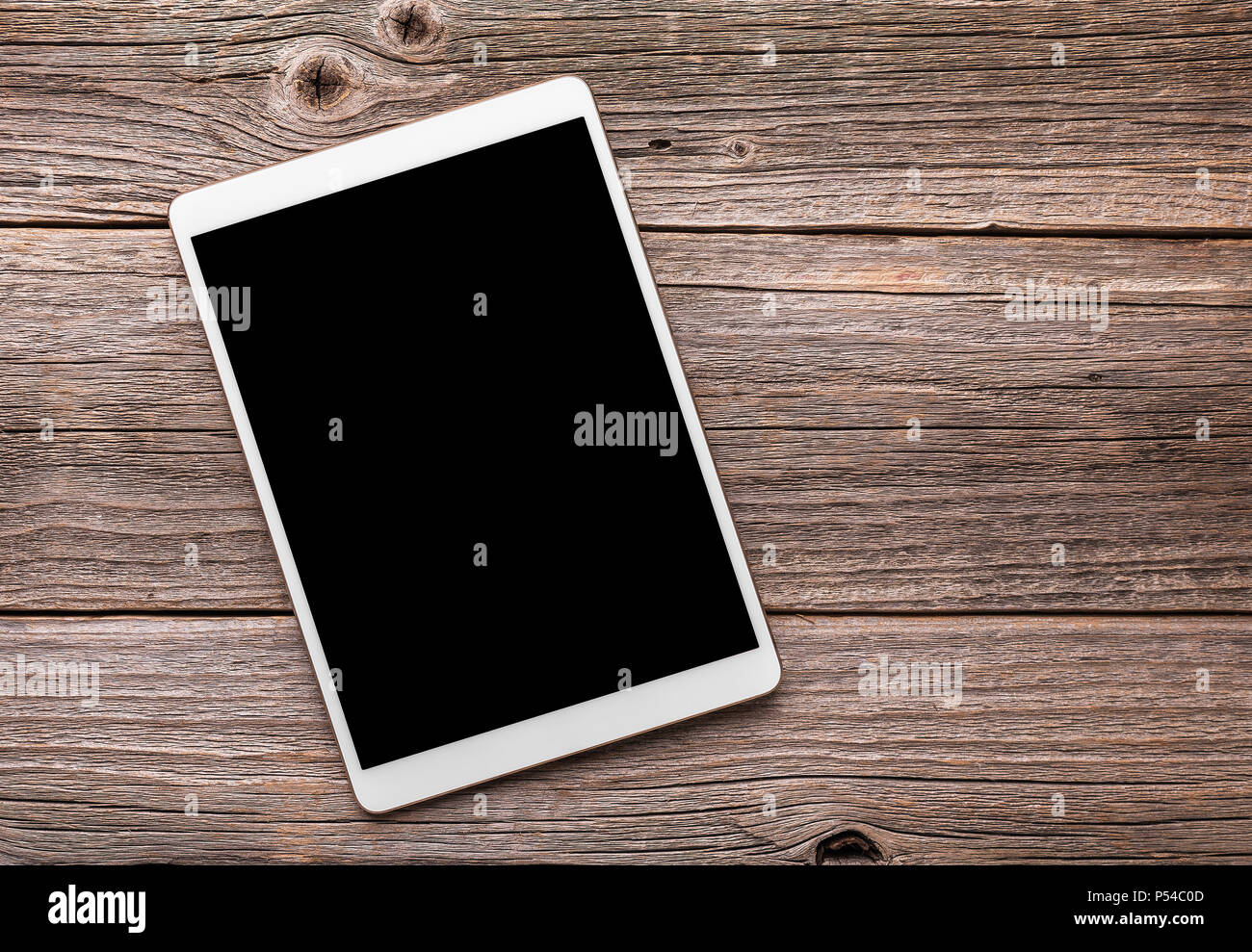 White tablet pc on old wood table background Stock Photo - Alamy