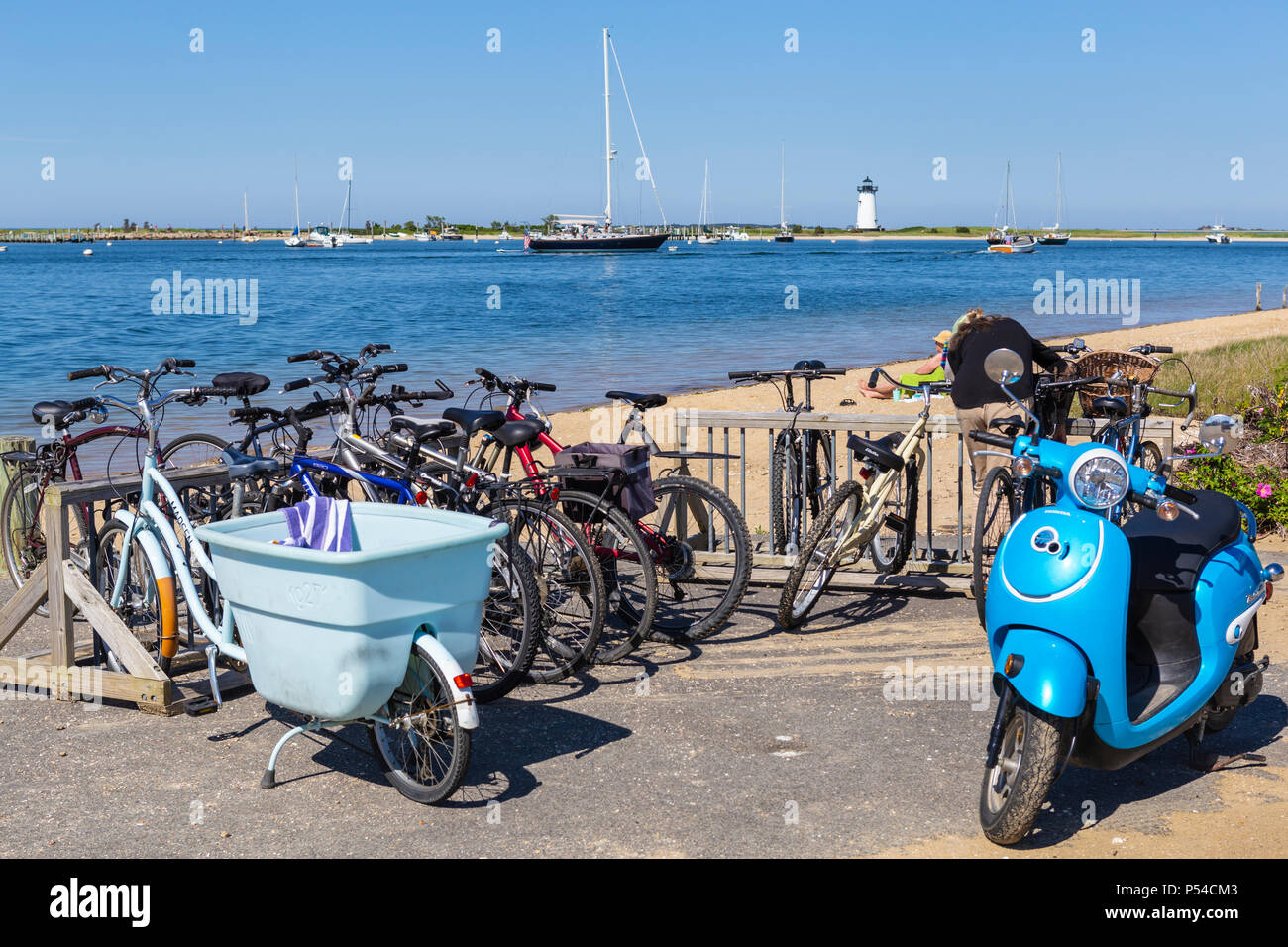 Bicycles and scooters parked next to the dock for the Chappy Ferry on ...