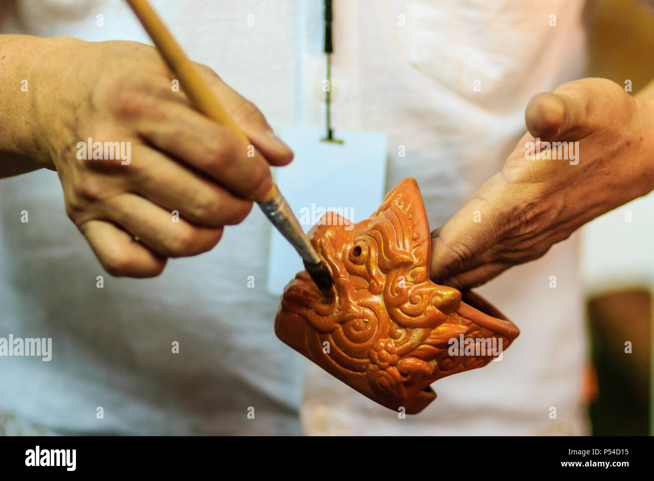 Close up hand of Thai sculptor during painting the masterpiece of ...
