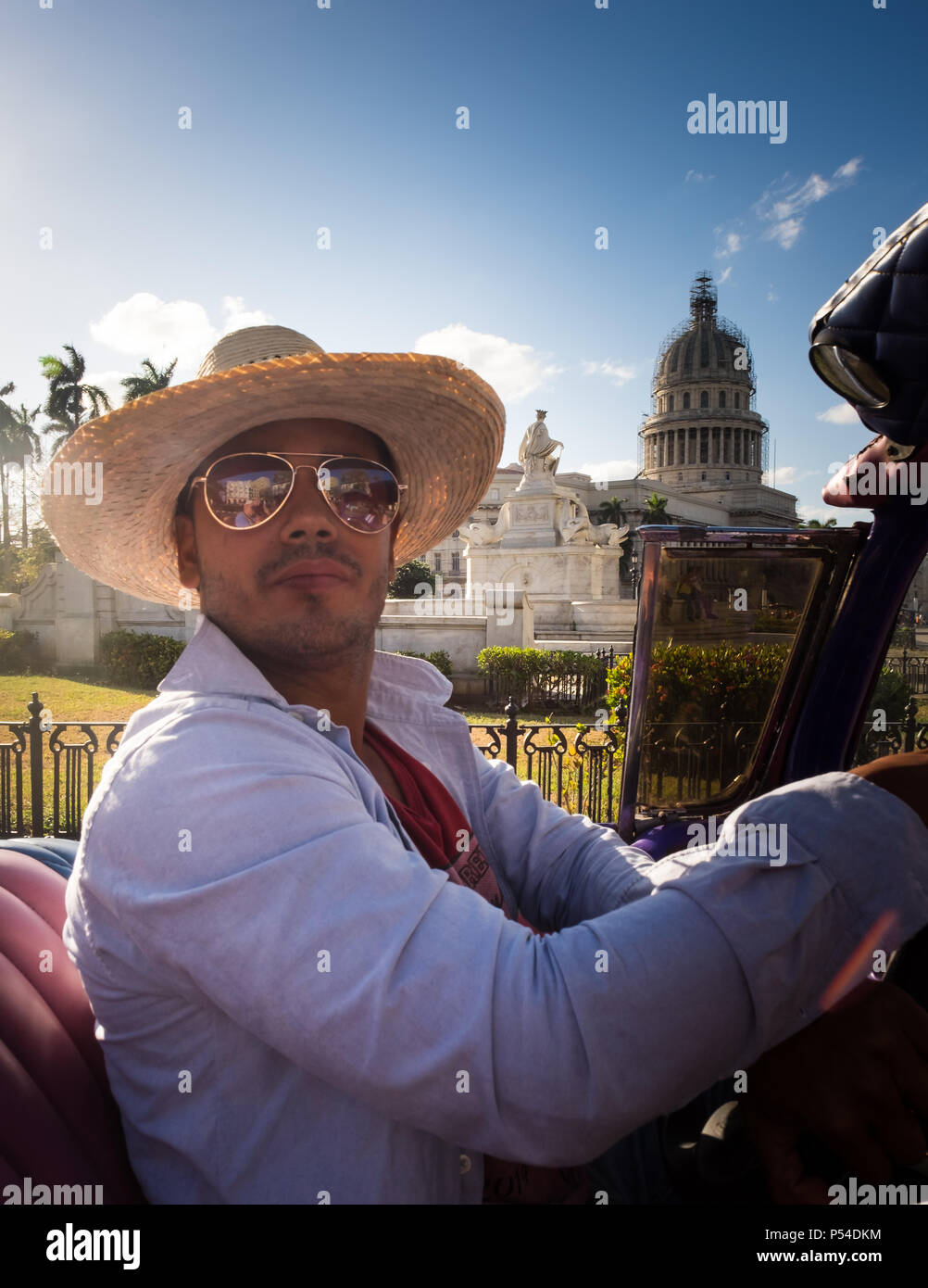 HAVANA, CUBA - CIRCA MAY 2016: Taxi driver of old convertible classic ...