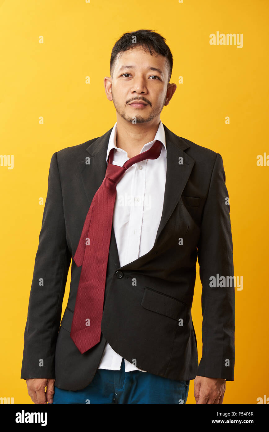 Messy asian office worker portrait isolated on yellow background Stock ...