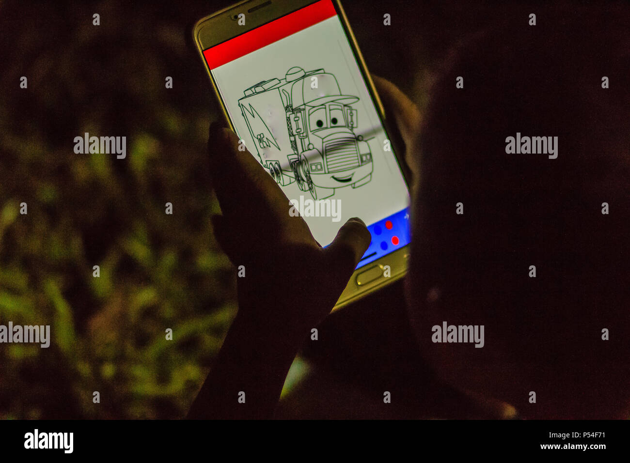 Asian boy is concentrate to drawing with mobile phone application in ...