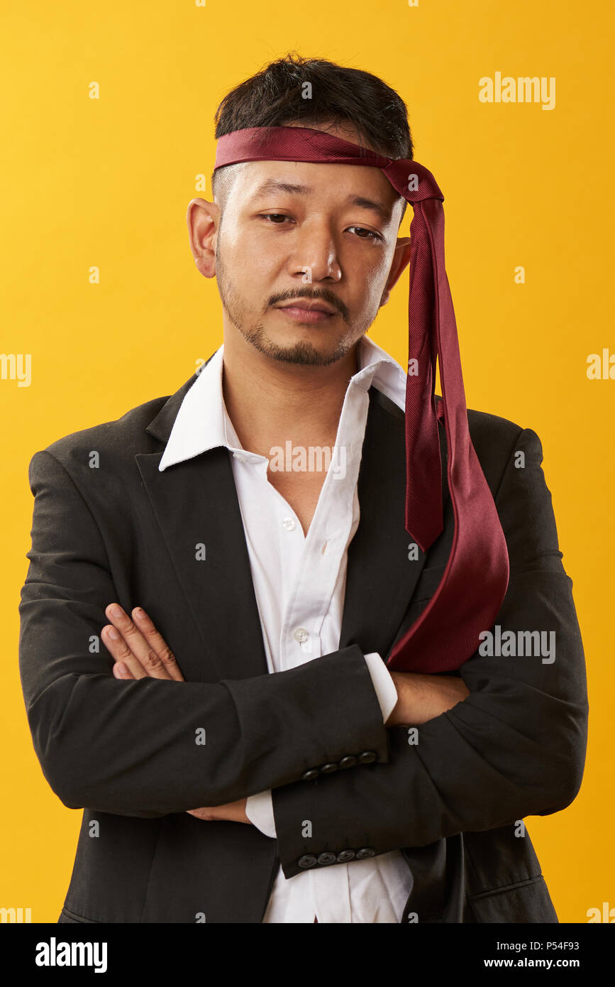 Upset asian office worker young man isolated on yellow background Stock ...