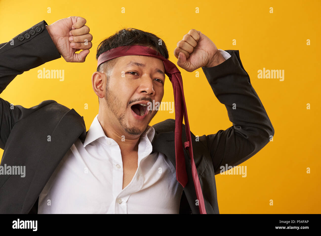 Asian office worker yawning after long working day Stock Photo - Alamy