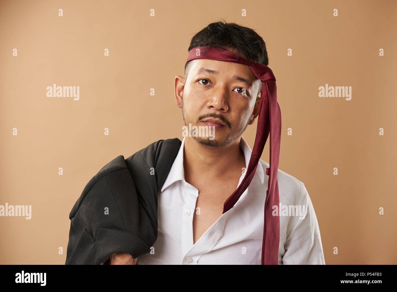Sad asian office worker with jacket on his shoulder Stock Photo - Alamy