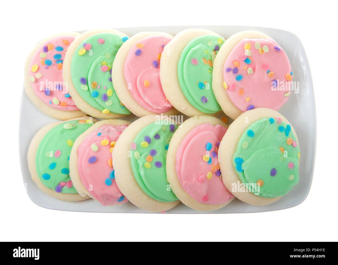 White rectangular plate with frosted sugar cookies sprinkles on top ...