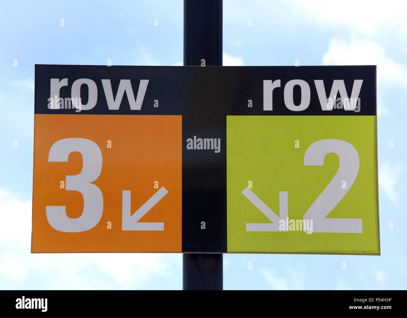 Parking lot row number signs 2 and 3 with blue cloudy sky in background ...