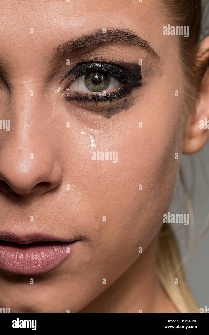 Sad crying girl looking into camera with smeared make-up Stock Photo ...