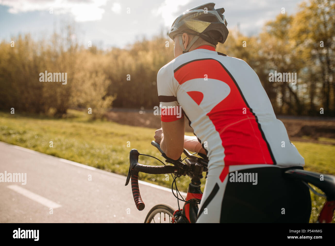Male bycyclist in sportswear, cycling on bike path. Sportsman rides on ...