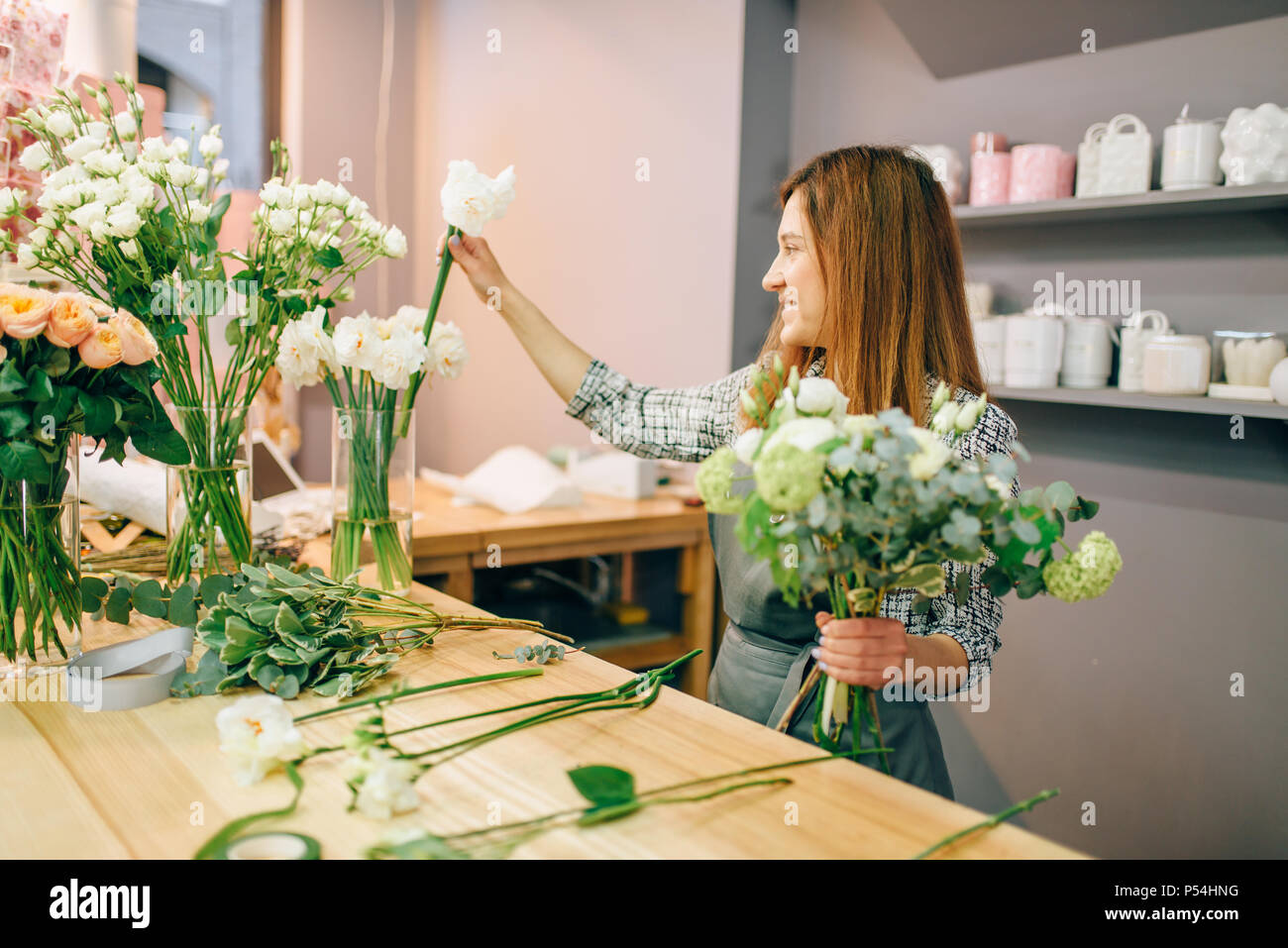Female florist places flowers hi-res stock photography and images - Alamy